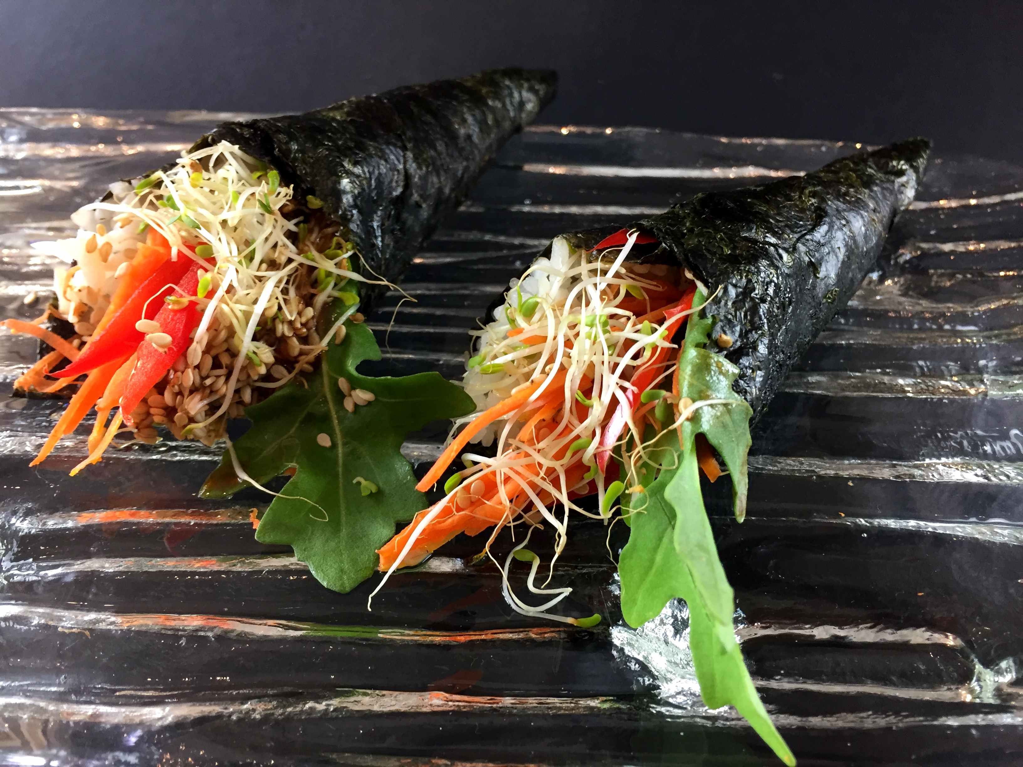 Seaweed rolls of alfalfa, carrot, capsicum, rocket and sesame seeds ...